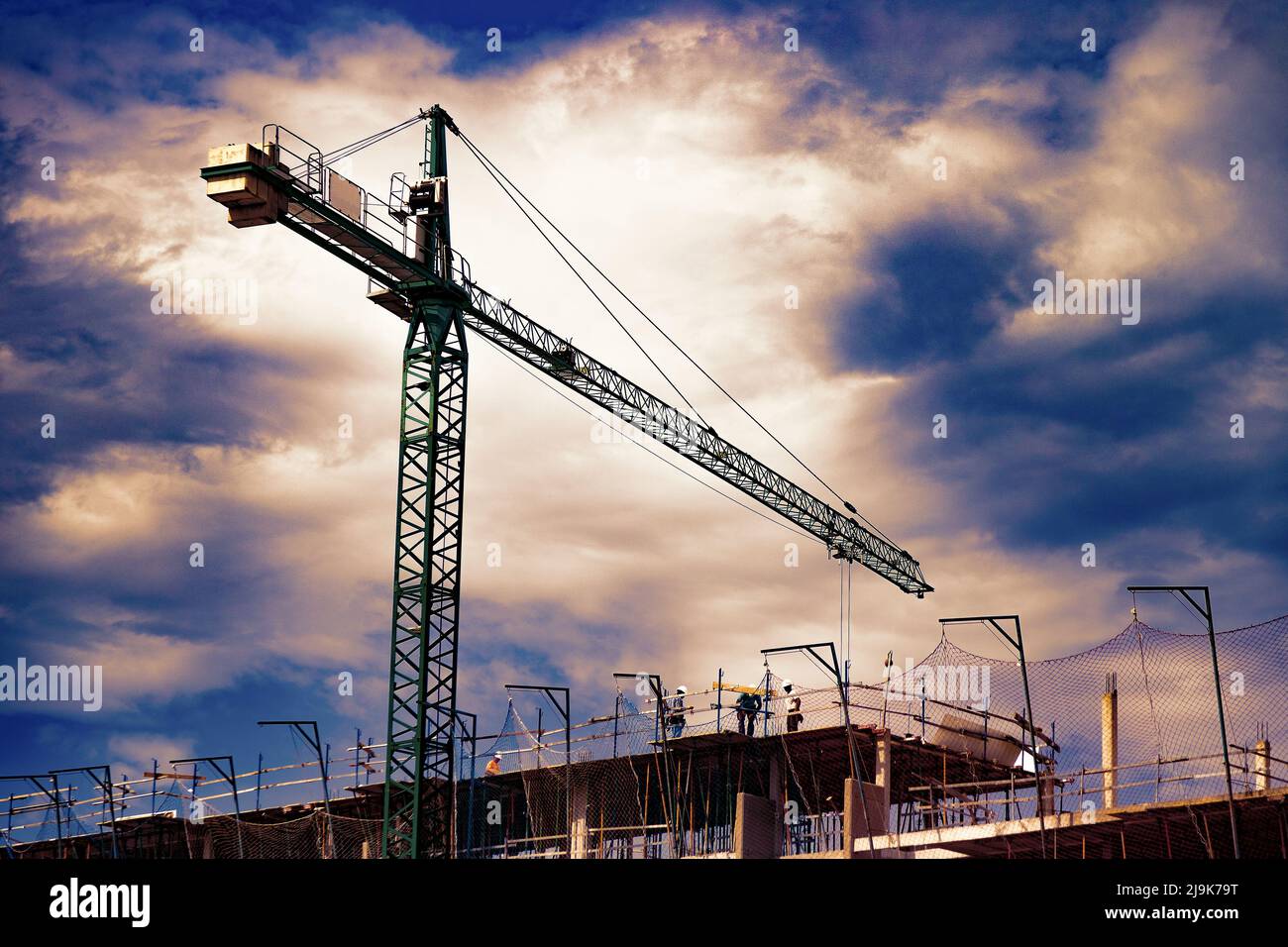 Sunset landscape and construction cranes and buildings. Construct with ...