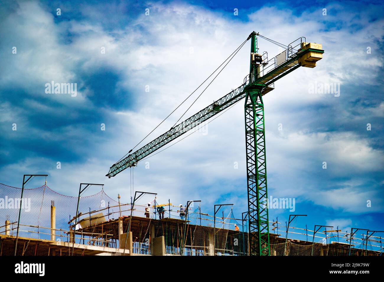 Sunset landscape and construction cranes and buildings. Construct with ...