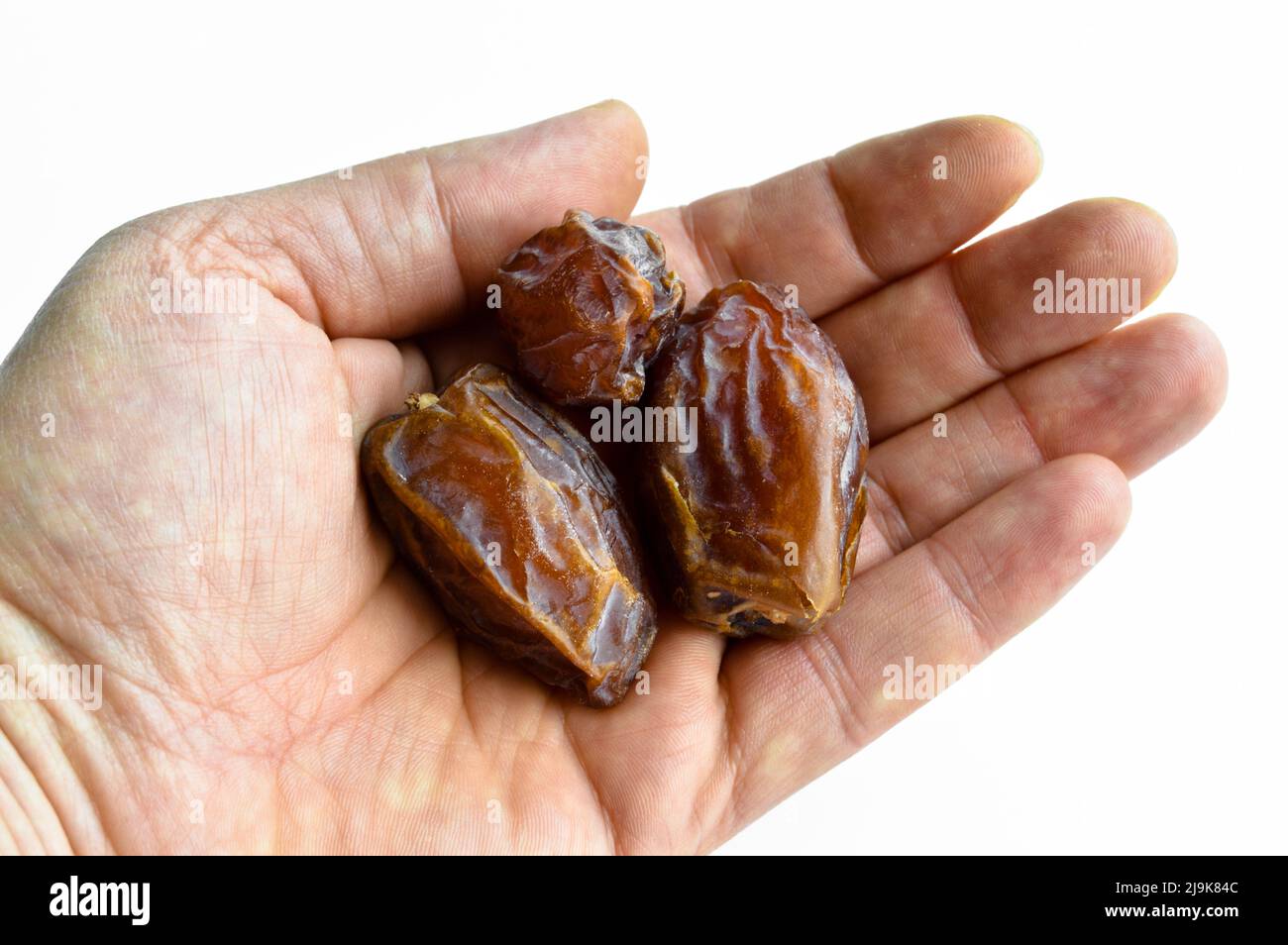 Organic fresh nutritious dried hurma dates medjool grains, isolated on ...