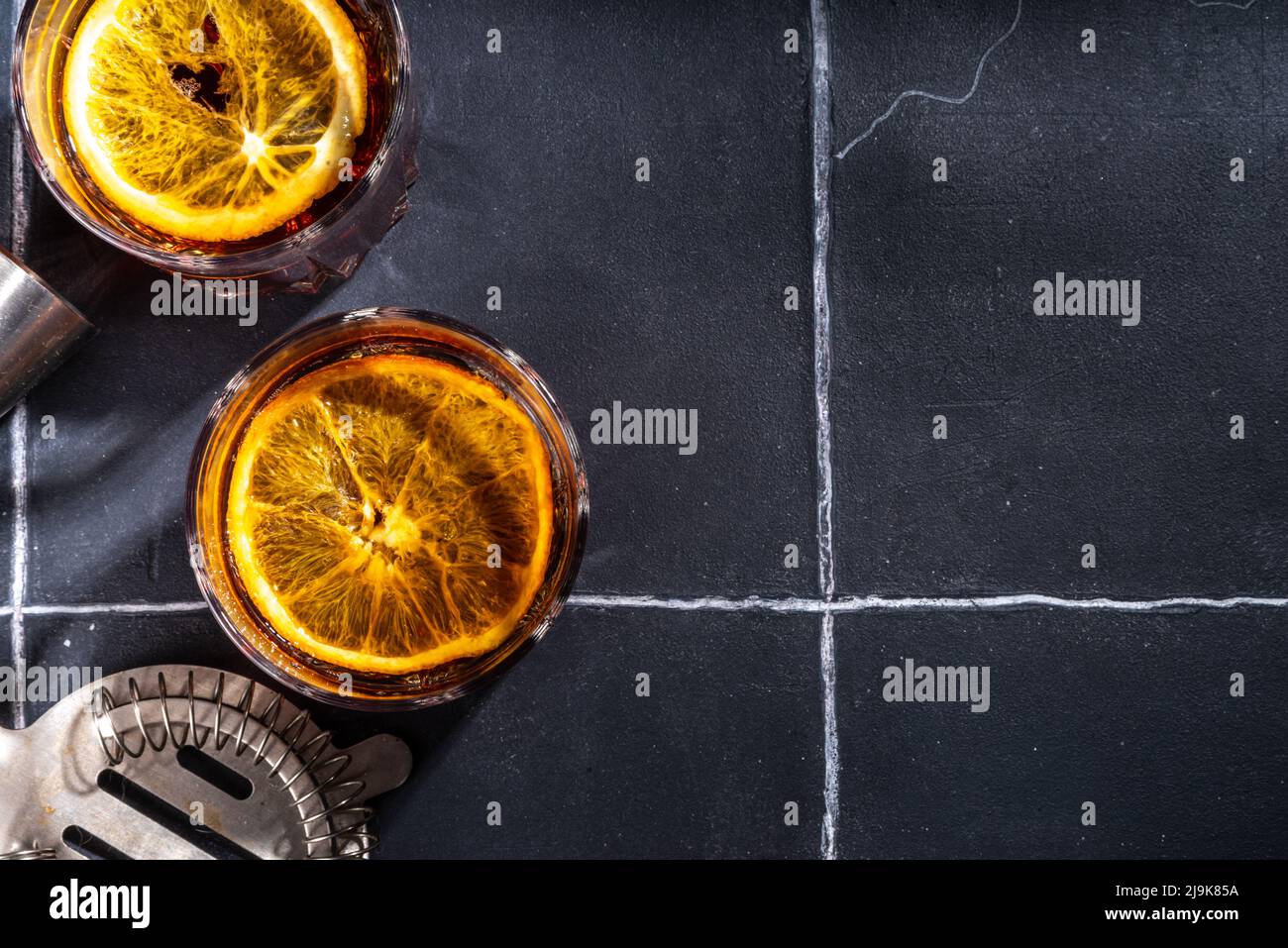Hard alcohol drink with orange slice garnish. Negroni cocktail with ...