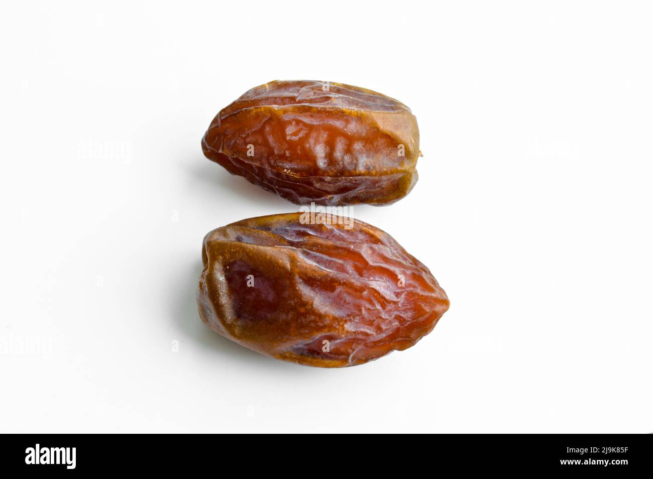 Organic fresh nutritious dried hurma dates medjool grains, isolated on ...