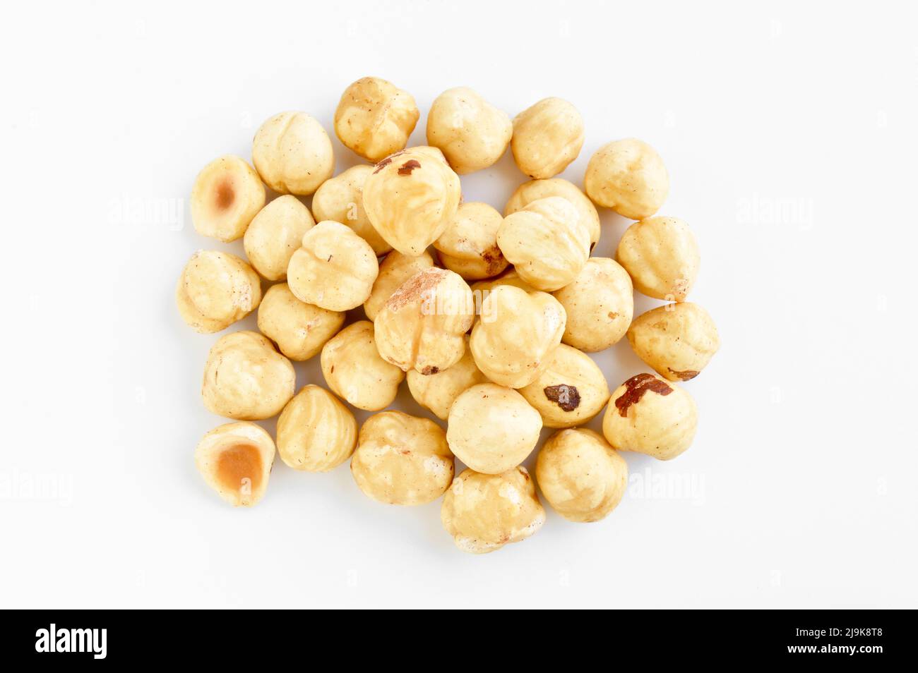 Pile of fresh organic roasted and peeled hazelnut kernels, isolated on ...