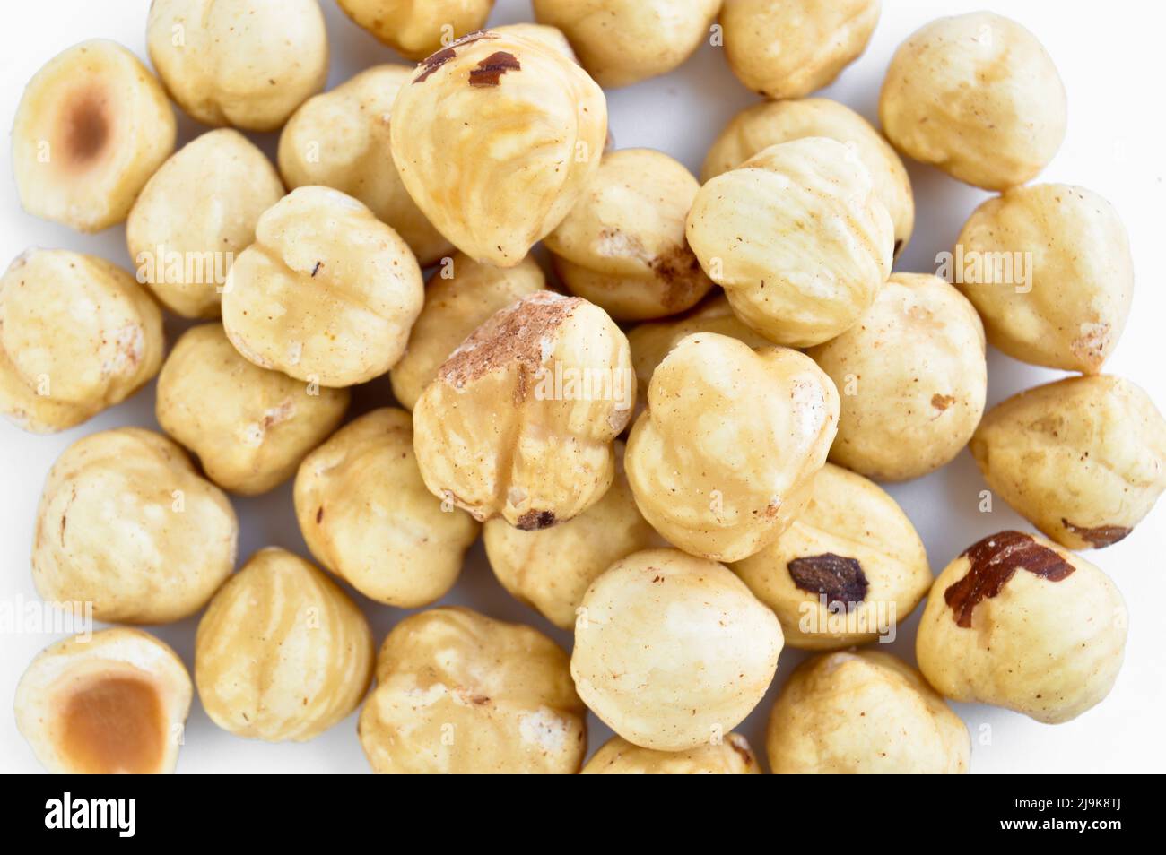 Pile of fresh organic roasted and peeled hazelnut kernels, isolated on ...