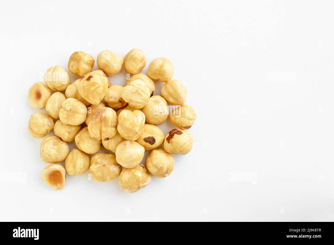 Pile of fresh organic roasted and peeled hazelnut kernels, isolated on ...