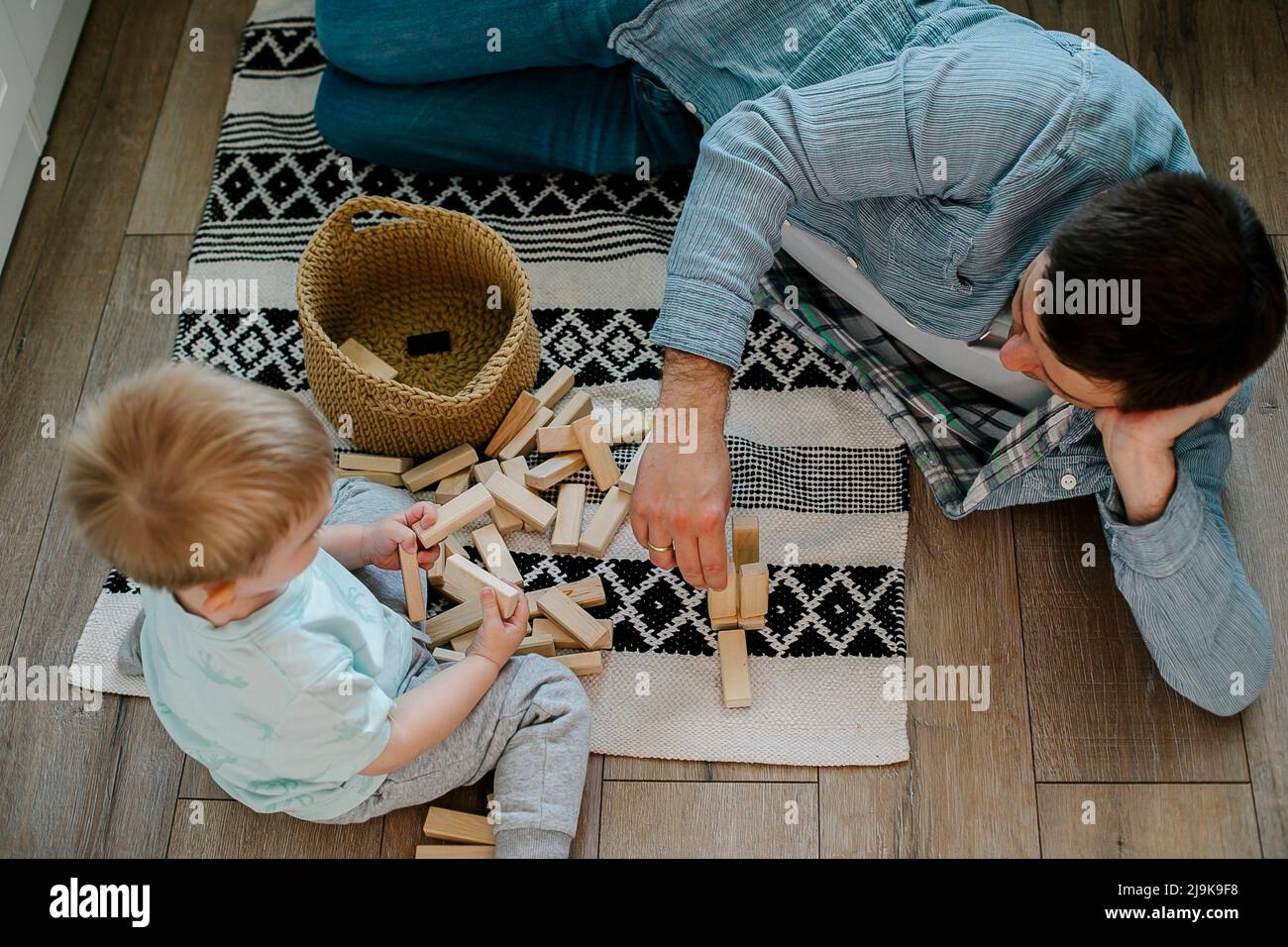 Happy father and toddler boy child little son playing with wooden ...
