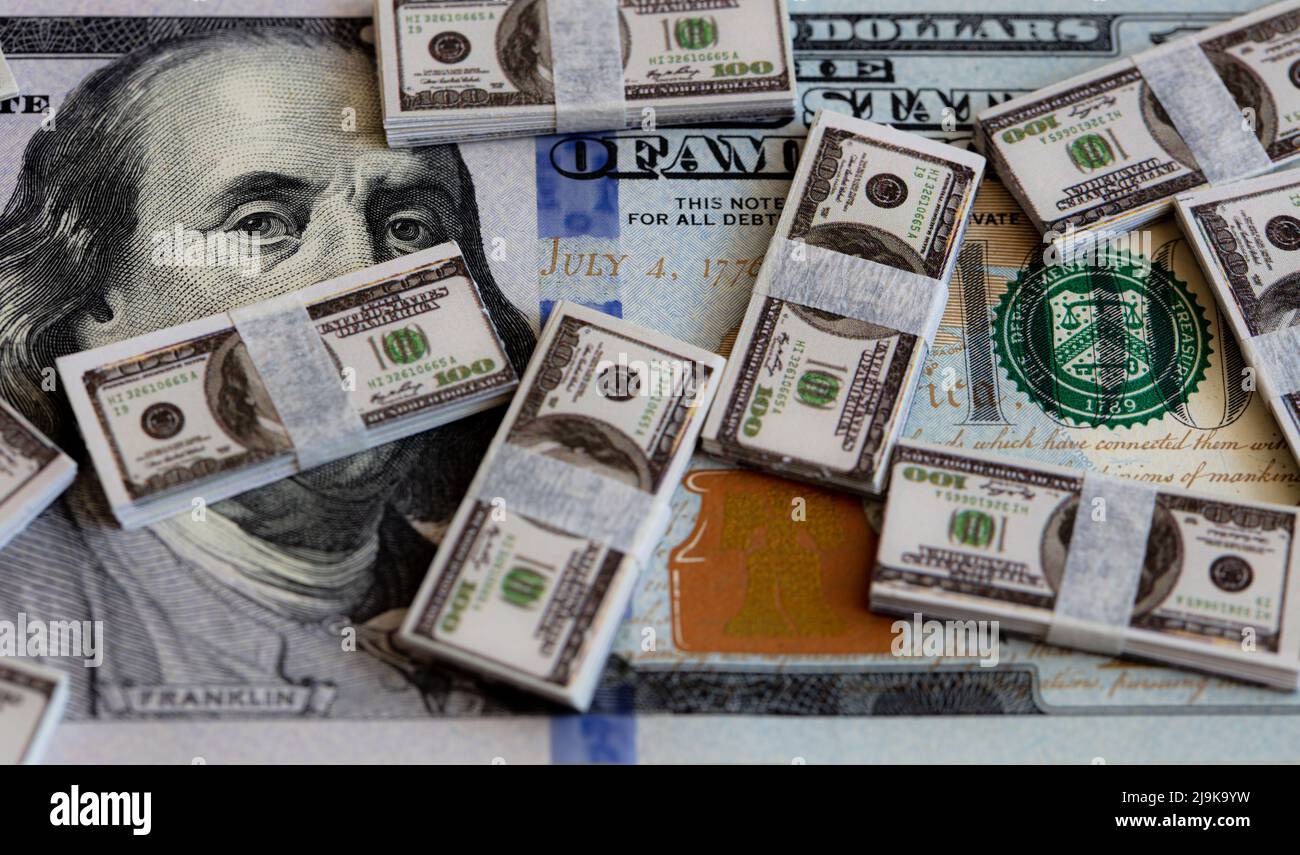 bundles of miniature 100 dollar banknotes on 100 dollar banknote ...