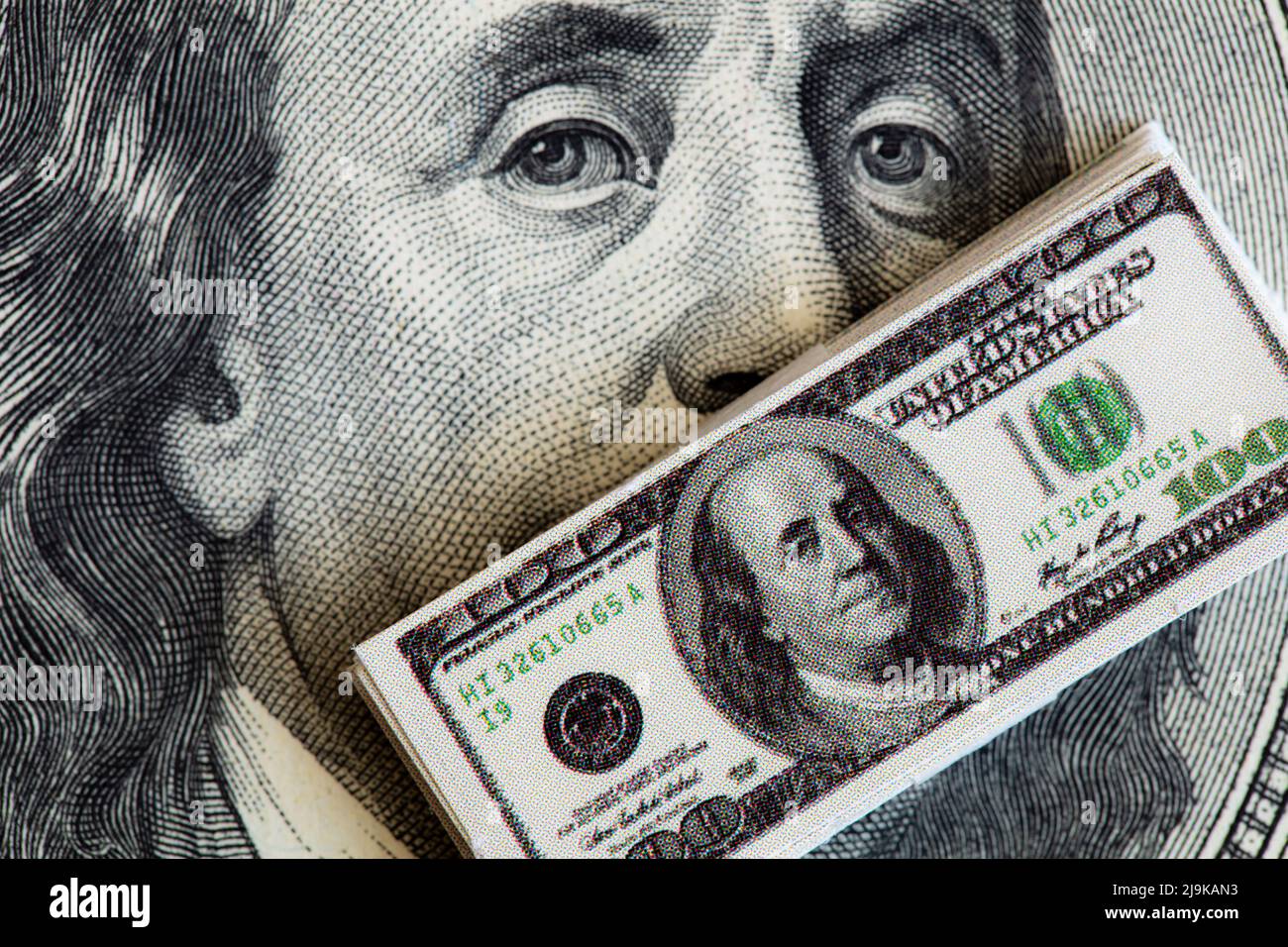 bundles of miniature 100 dollar banknotes on 100 dollar banknote ...