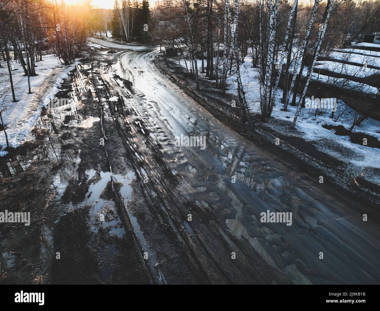 Broken old asphalt road outside the city. Pits and potholes. Aerial ...