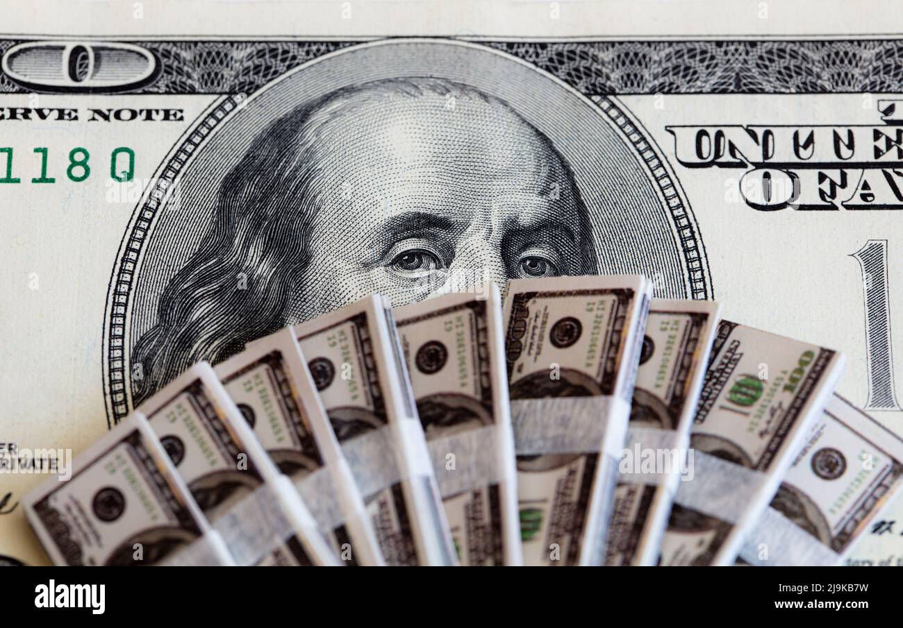 bundles of miniature 100 dollar banknotes on 100 dollar banknote ...