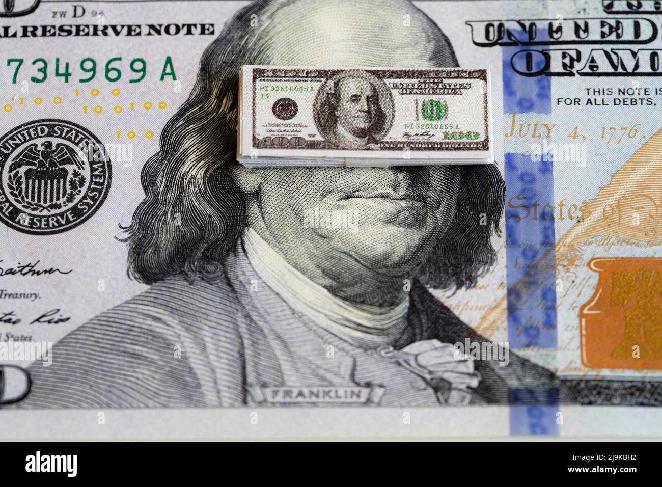 bundles of miniature 100 dollar banknotes on 100 dollar banknote ...