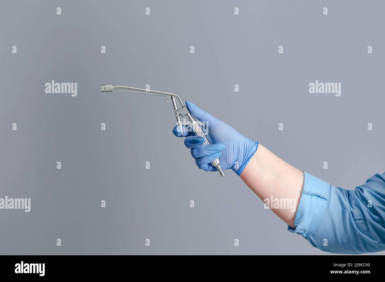 Proctology. Doctor's hand in medical glove holds medical instruments to ...