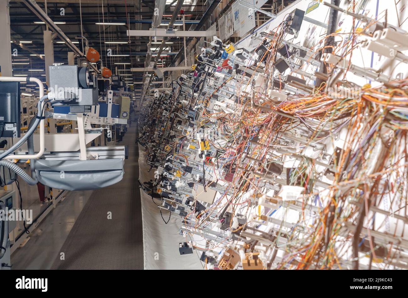Side view of production room with stands for manufacture of electrical ...