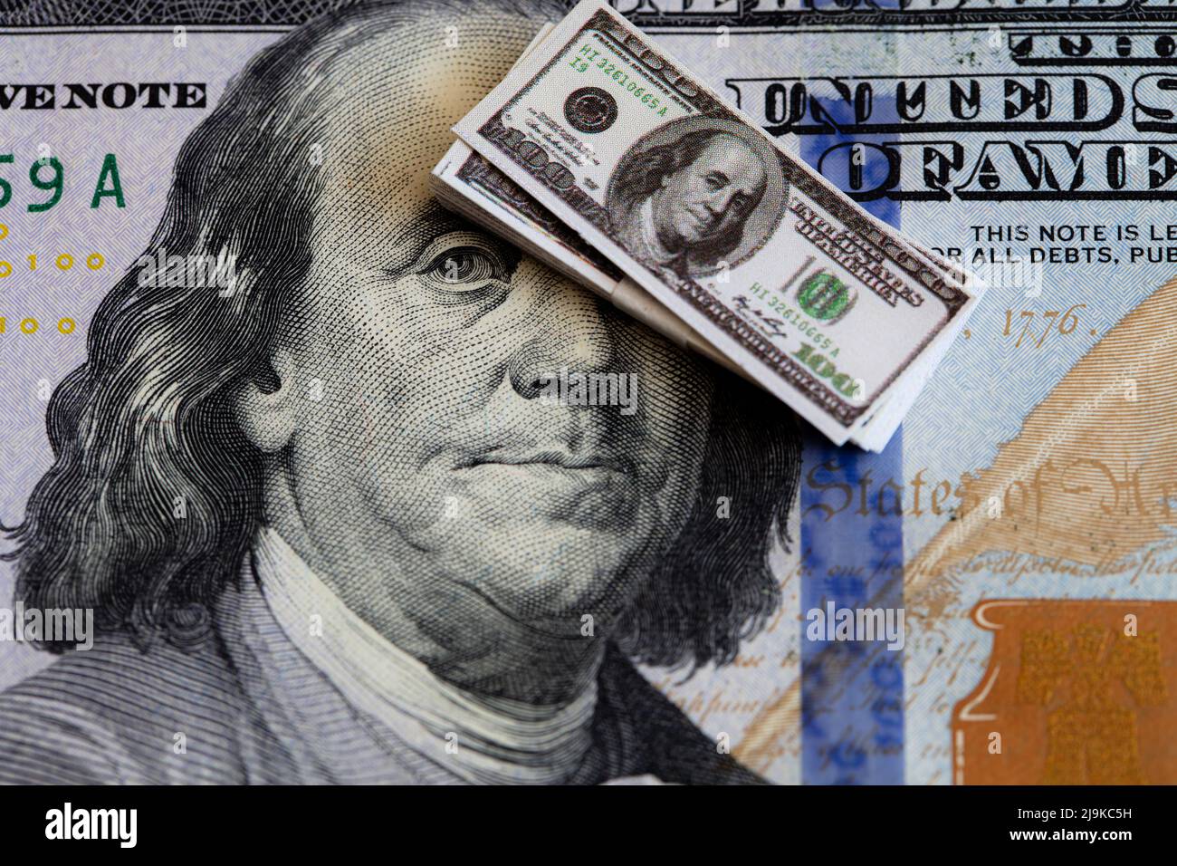 bundles of miniature 100 dollar banknotes on 100 dollar banknote ...