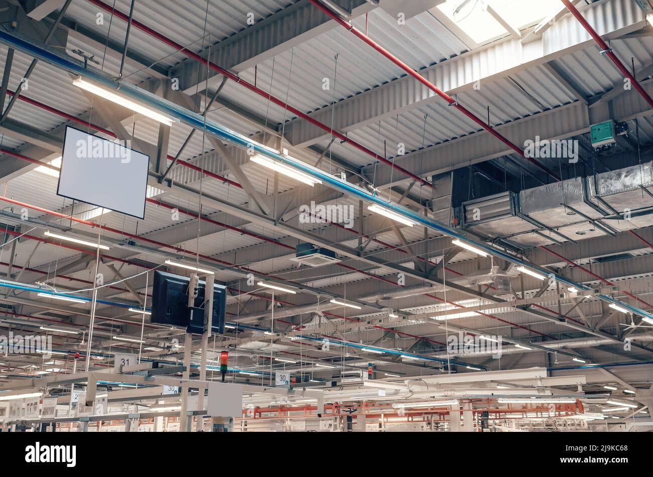 Ceiling of large factory building with artificial lighting. Industrial ...