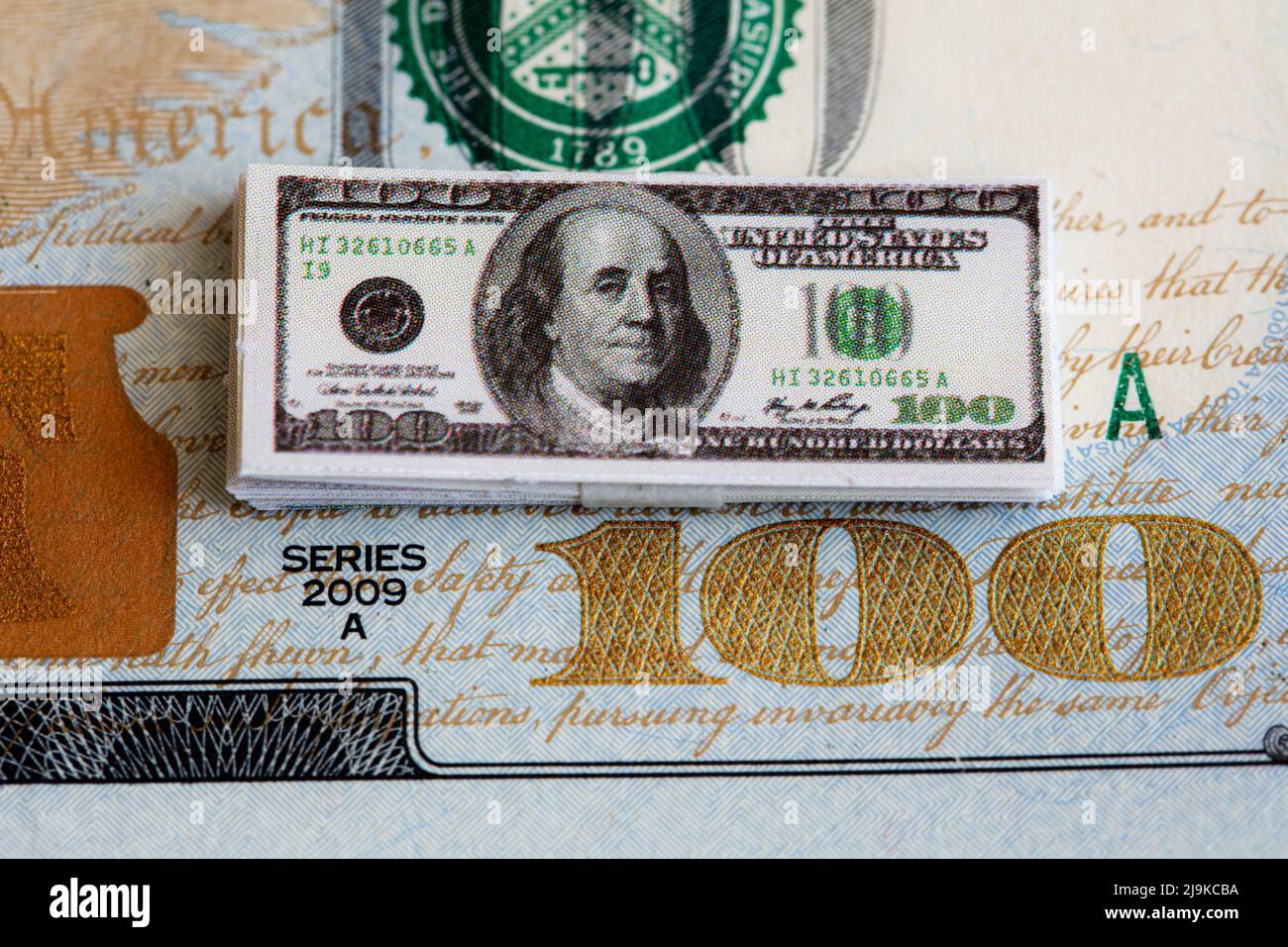 bundles of miniature 100 dollar banknotes on 100 dollar banknote ...