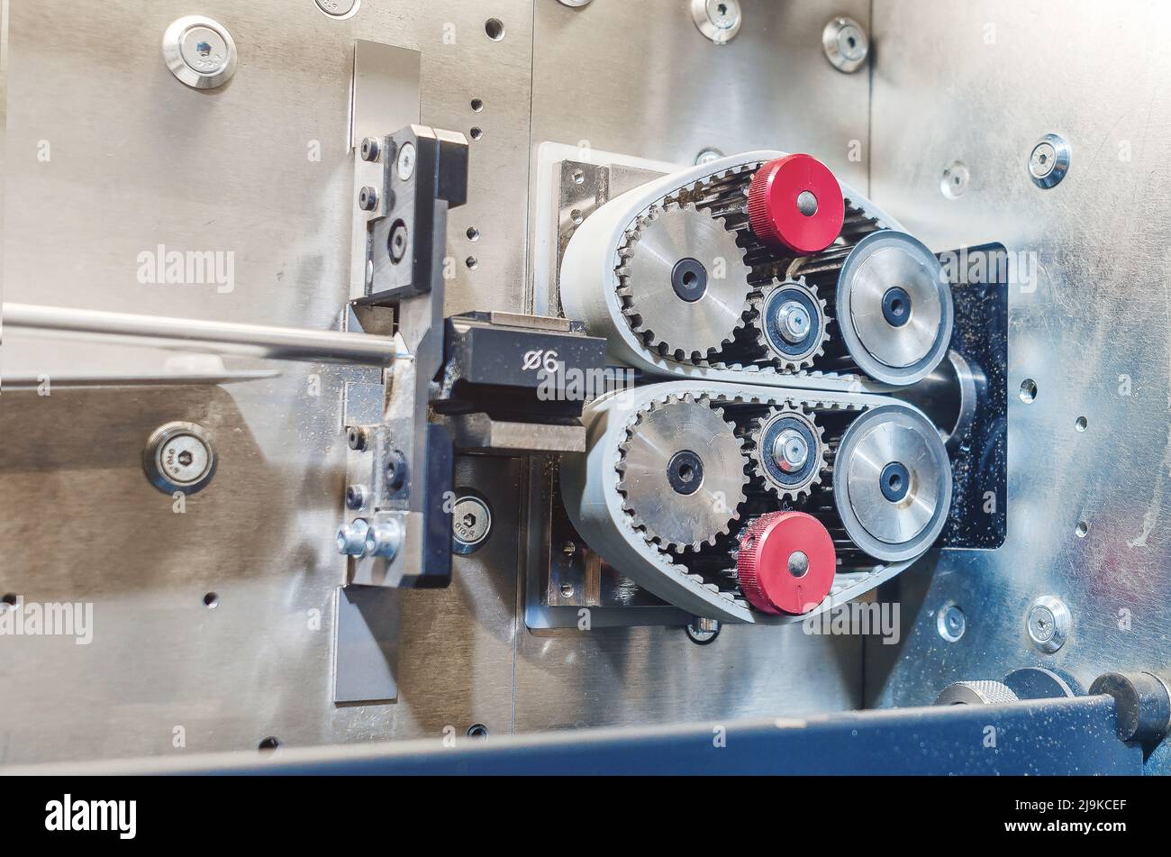 Pulling wire through gears on machine. Part of industrial equipment at ...