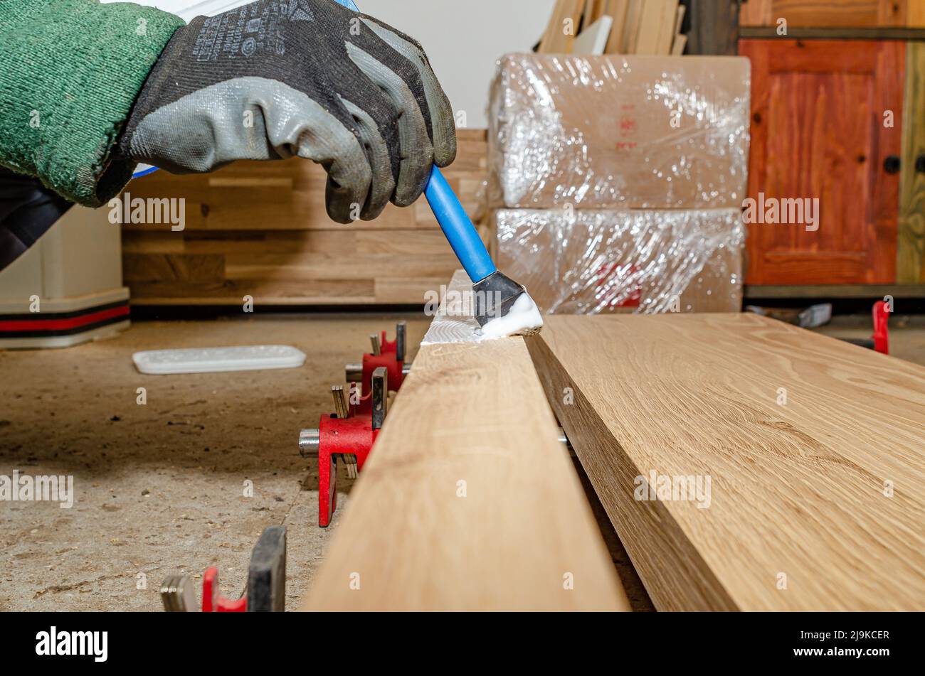 Process of painting wooden board. Hand with brush Stock Photo - Alamy