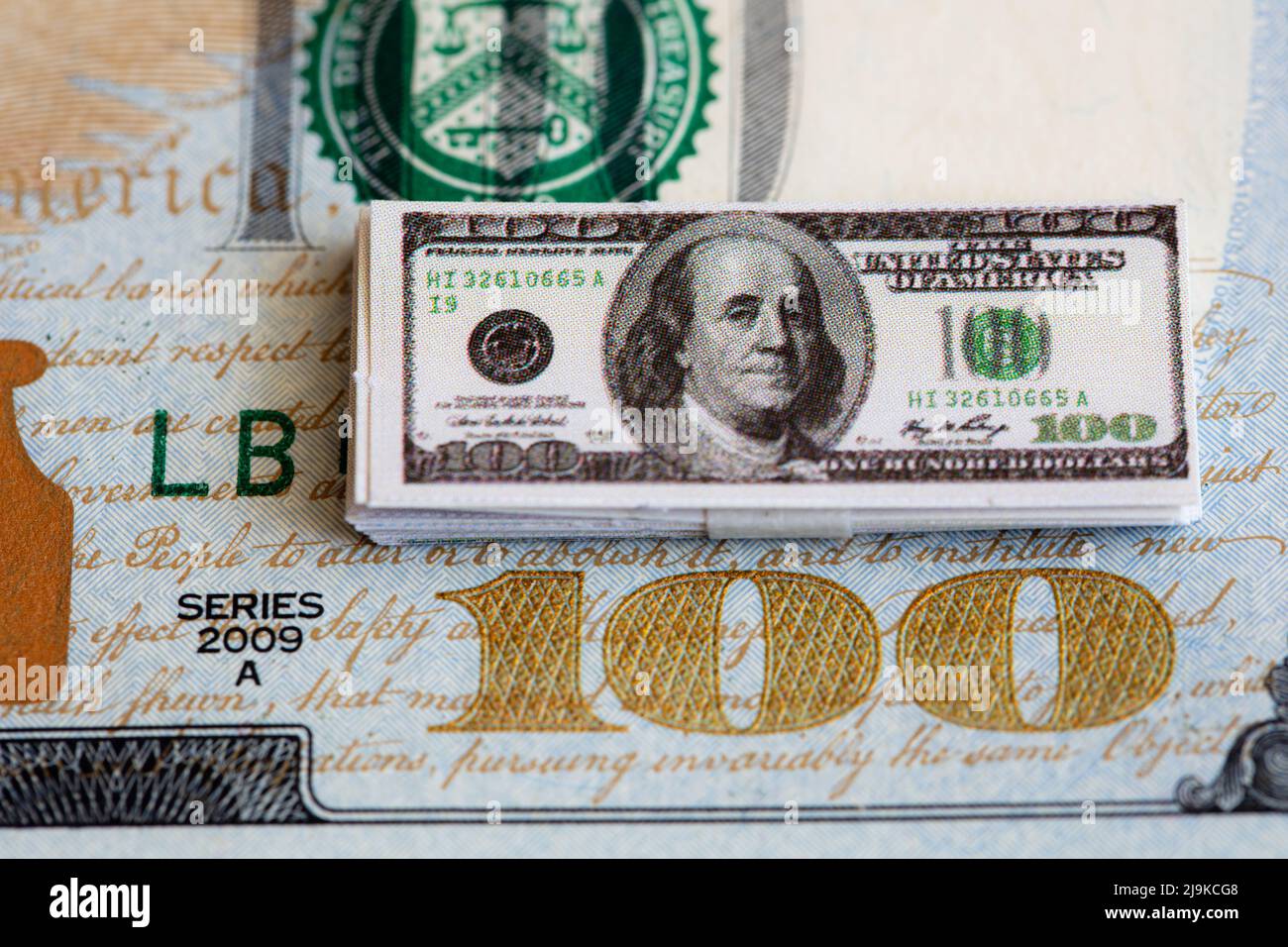 bundles of miniature 100 dollar banknotes on 100 dollar banknote ...