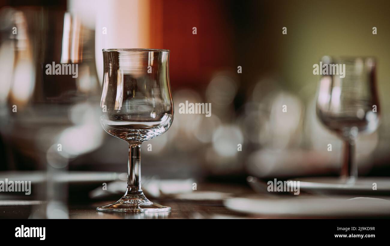 Close-up of an empty wine glass on the dining table Stock Photo - Alamy