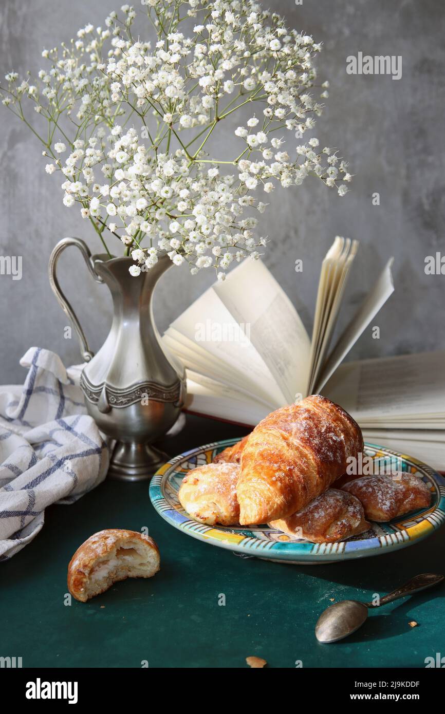 Good morning! Black coffee and croissants on a table. Sunny picture ...