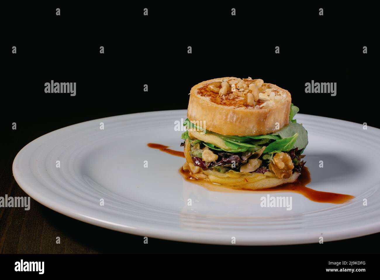 A close-up of a plate with the classic Spanish dish Timbal de Bacalao ...