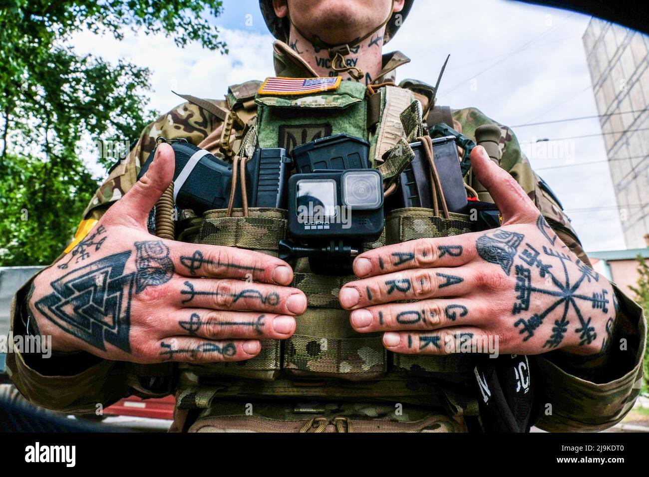 A soldier of special forces of Ukraine displays his tattoos. Lysychansk ...