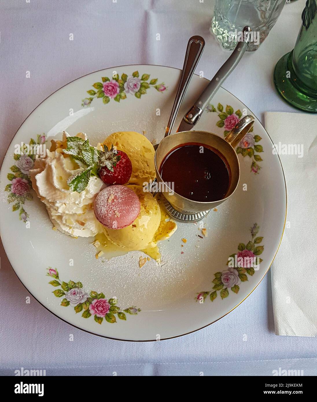 Delicious luxury dame blanche with a macaron, vanilla ice cream, melted ...