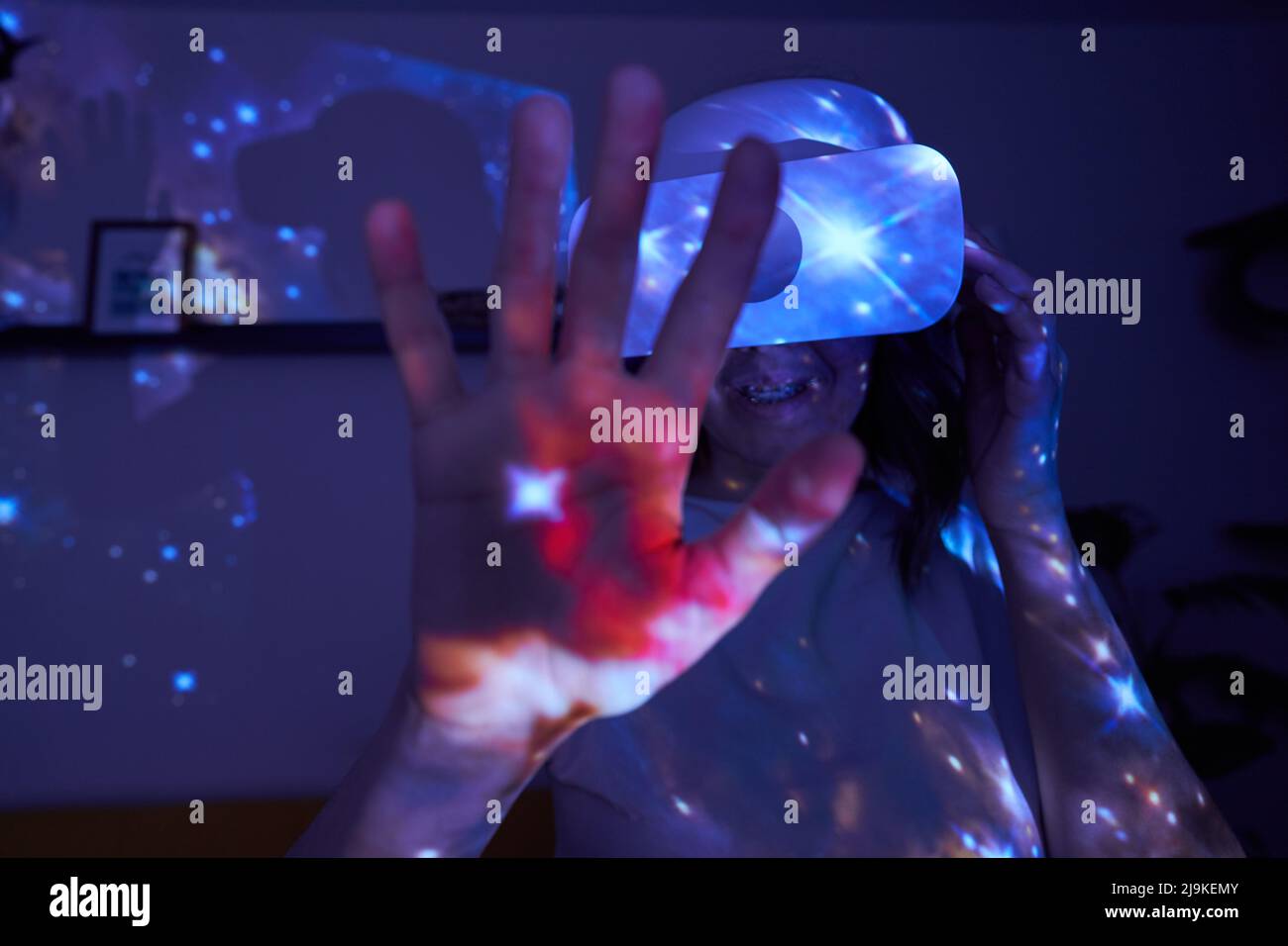 Woman is using virtual reality headset. Elements of this image ...