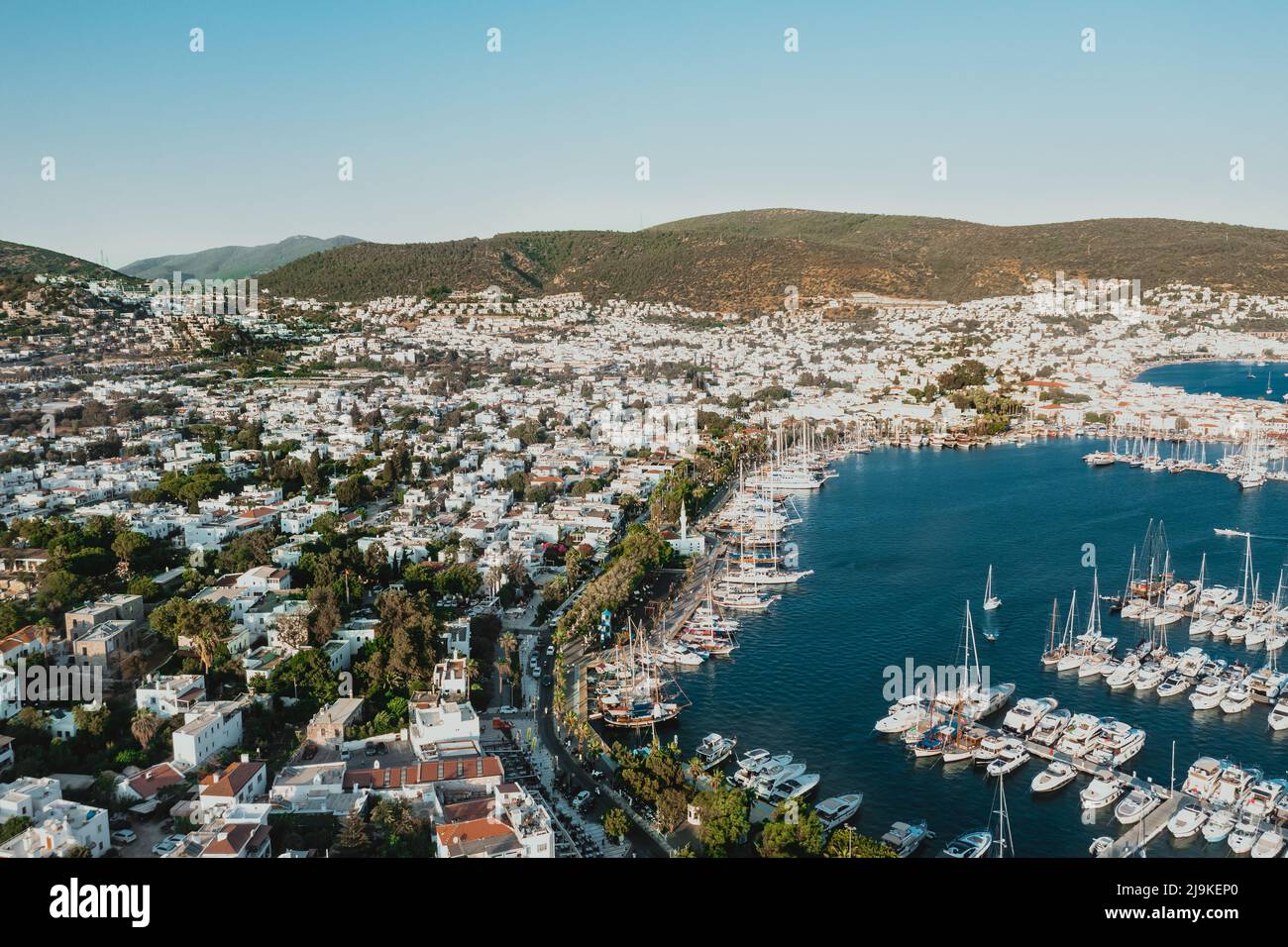 Aerial landscape of white villa homes in Bodrum Turkey during sunset ...