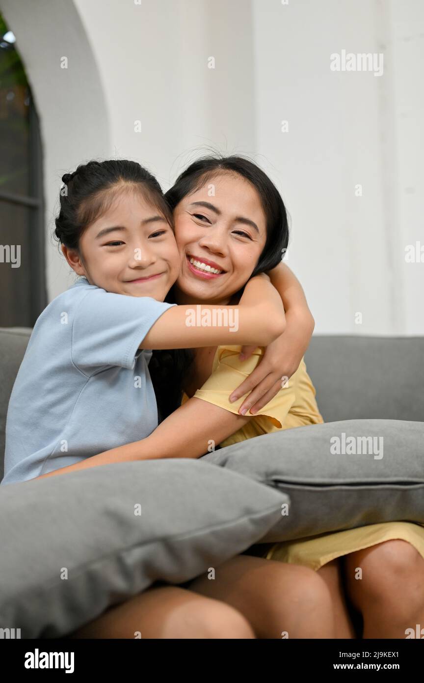 Portrait Of A Smiling Asian Mom And Young Daughter Sharing A Special Love Expression Moment