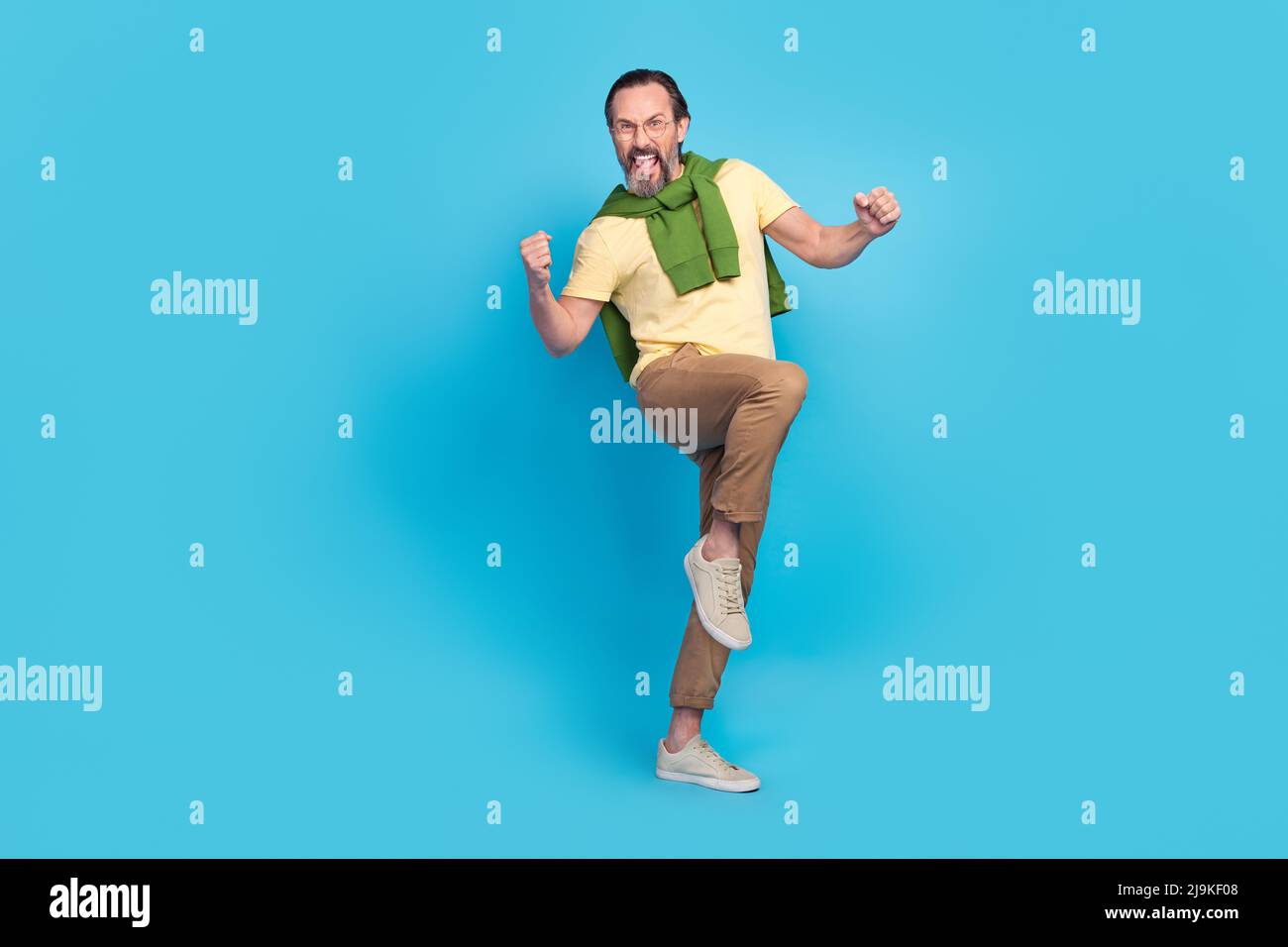 Full body photo of delighted astonished man raise fists luck ...