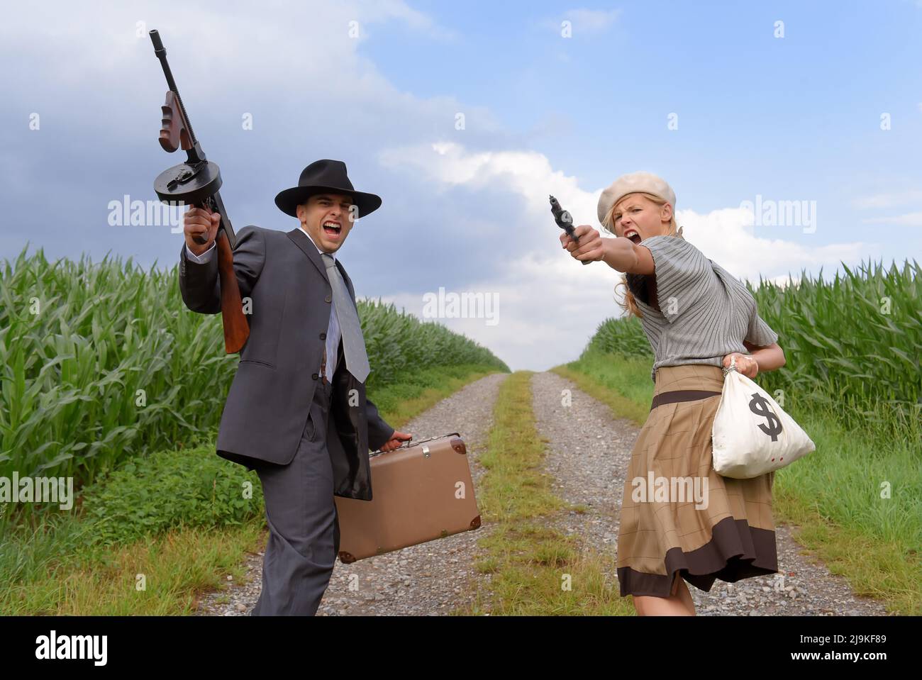 A young couple get dressed up in 1930 style clothing. They each carry a ...