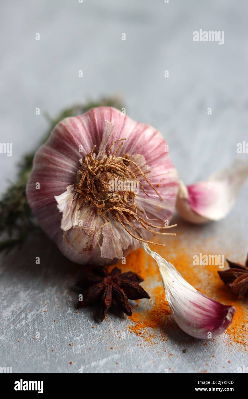 Spices on a table. Close up photo of garlic cloves and bulb, turmeric ...