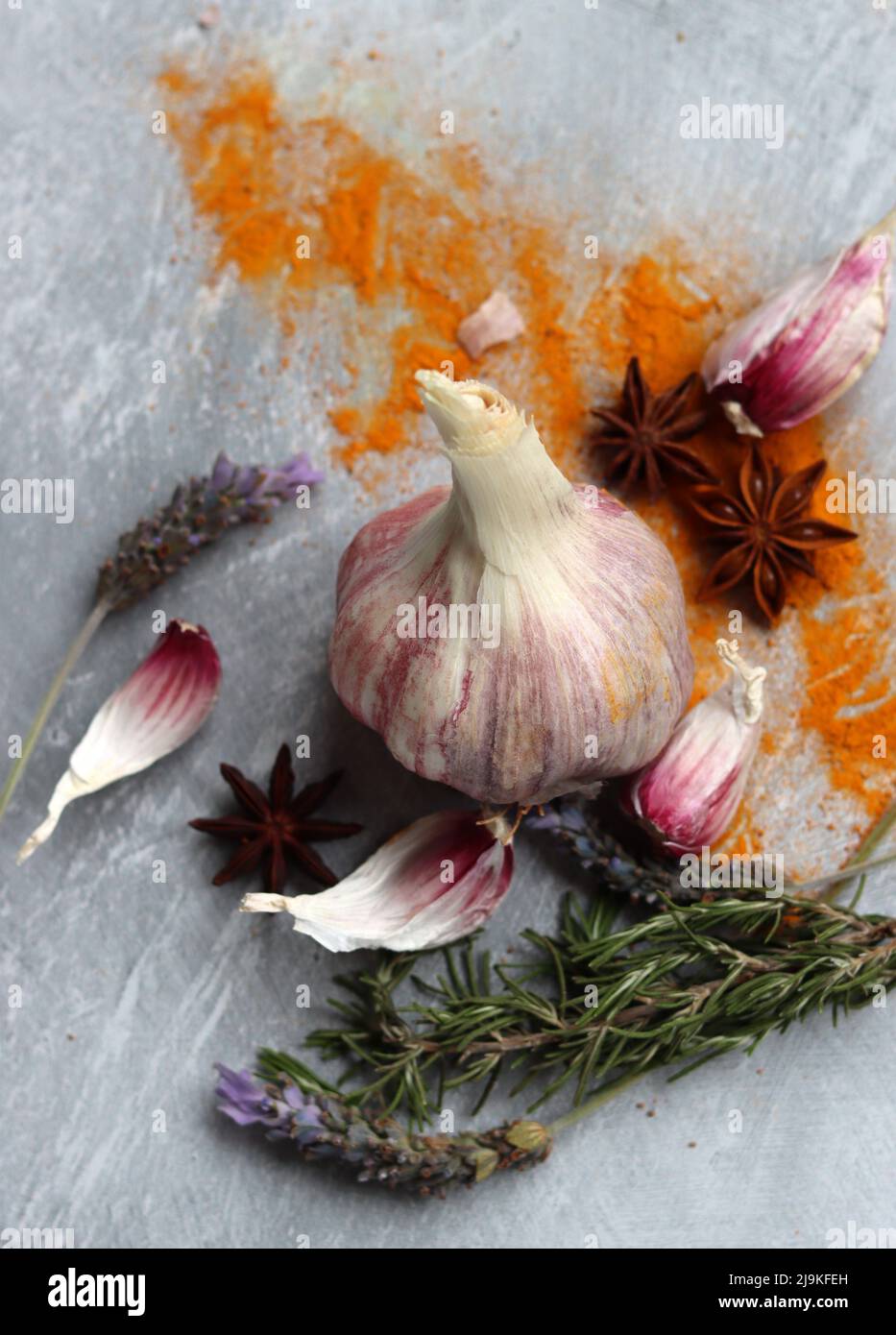 Spices on a table. Close up photo of garlic cloves and bulb, turmeric ...