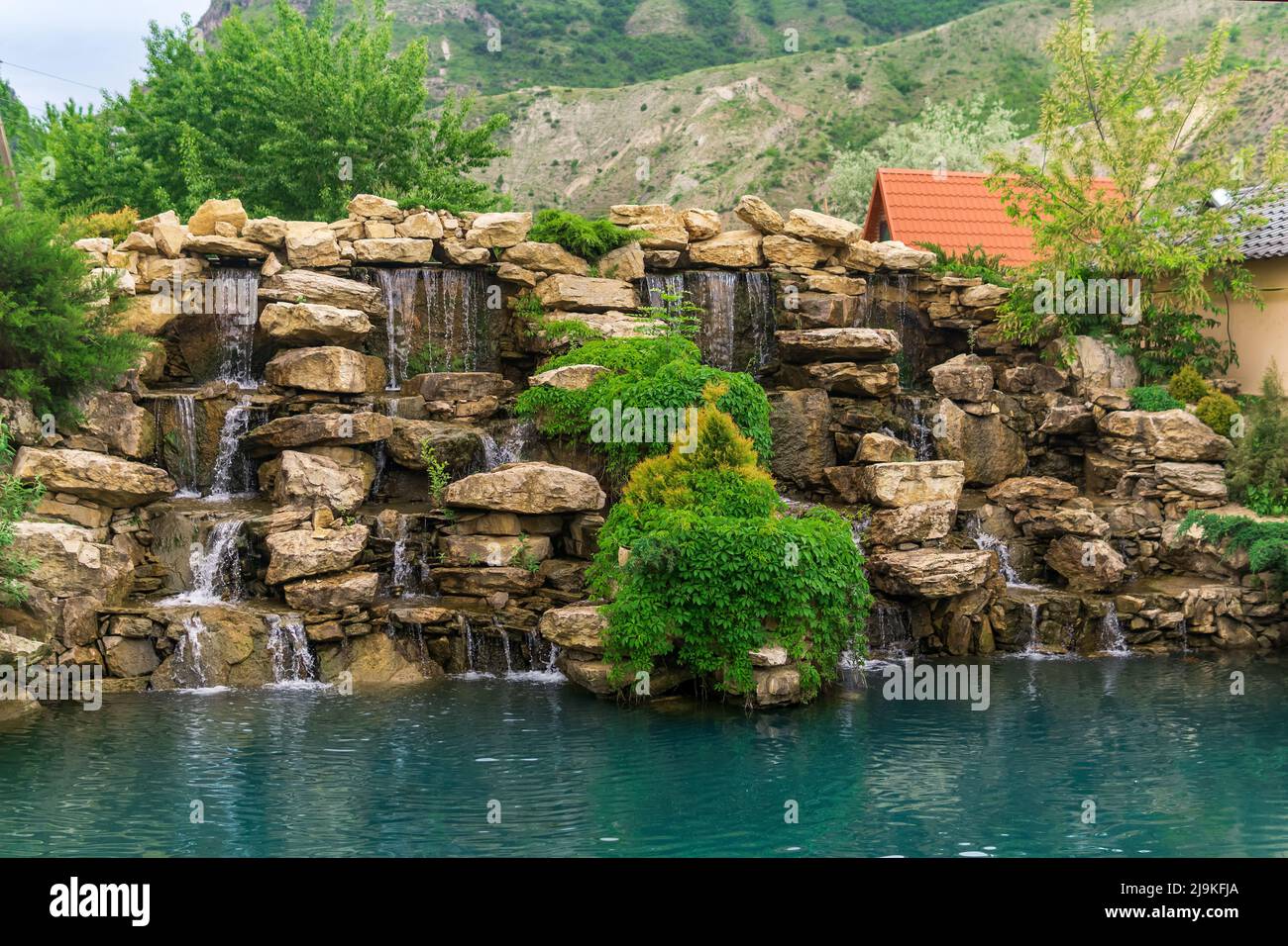 landscape design, a dam with a cascade of waterfalls in the form of ...