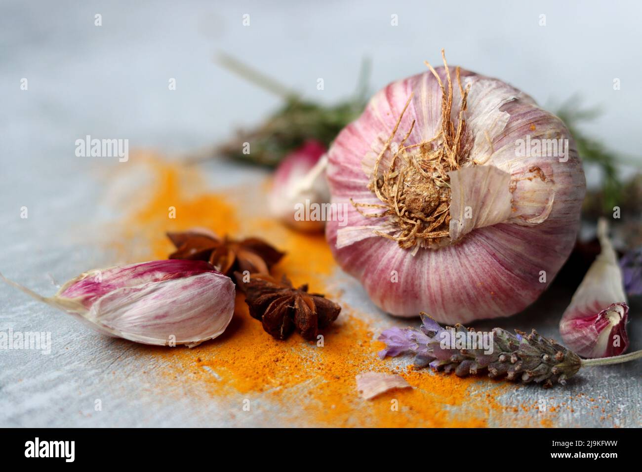 Spices on a table. Close up photo of garlic cloves and bulb, turmeric ...