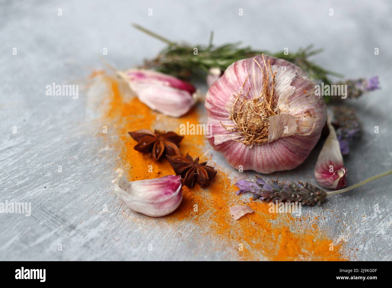 Spices on a table. Close up photo of garlic cloves and bulb, turmeric ...