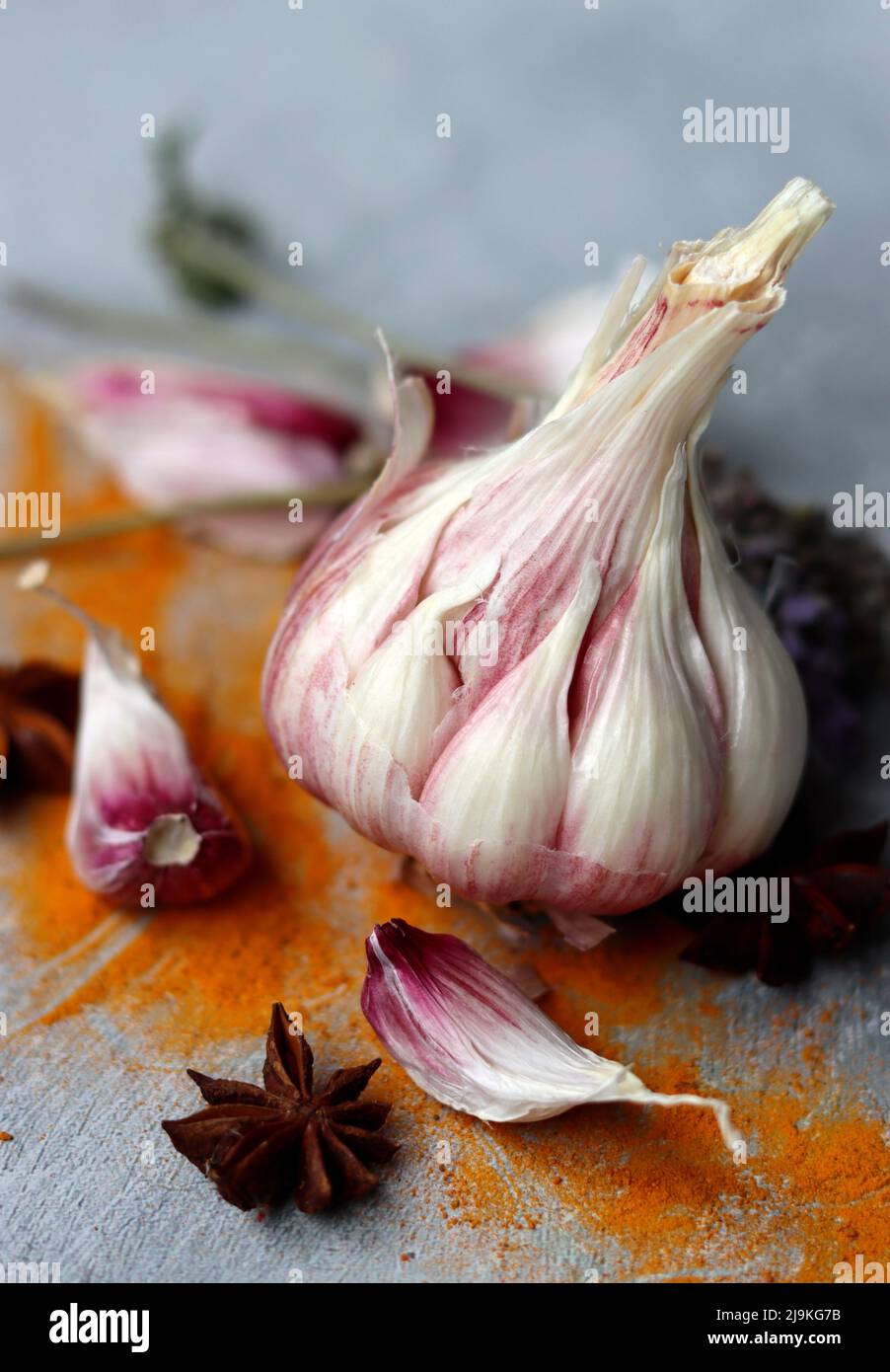 Spices on a table. Close up photo of garlic cloves and bulb, turmeric ...