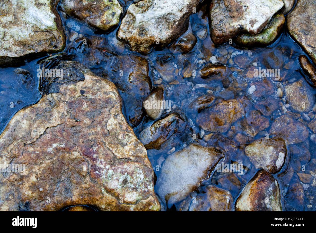 Rocks in Polluted Water Stock Photo - Alamy