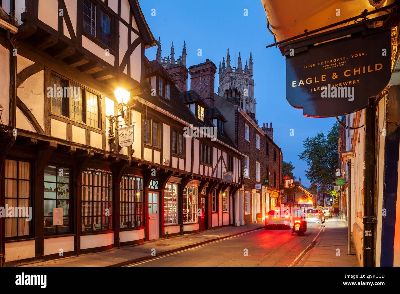 Evening on High Petergate in York, England. York Minster towers in the ...