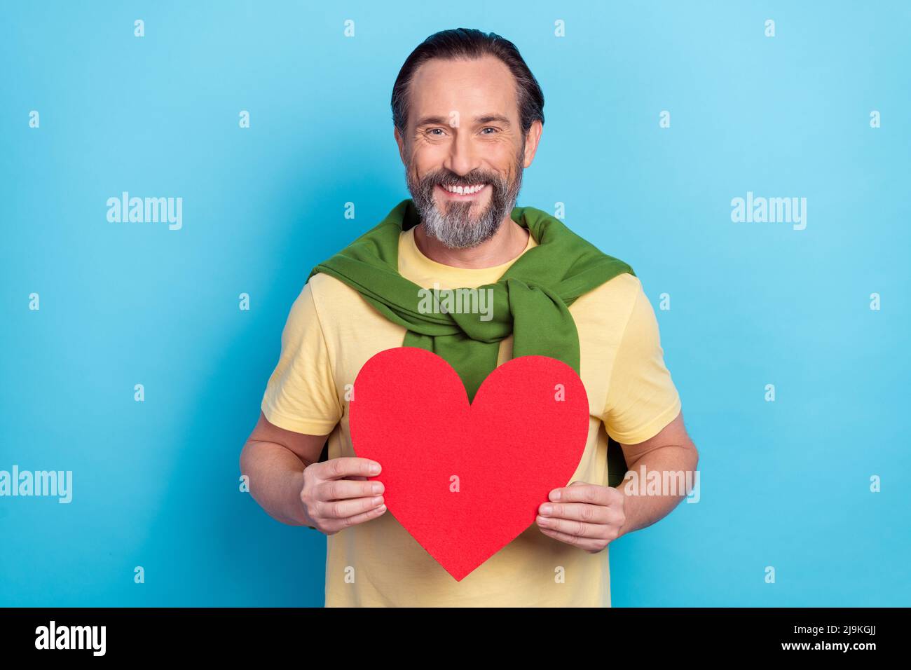 Portrait of satisfied glad person hold large heart symbol postcard look ...