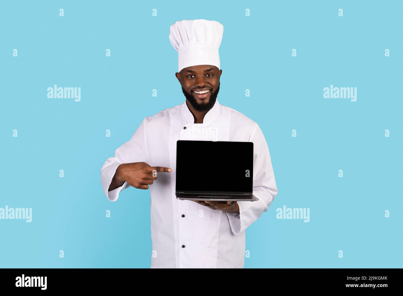 Cooking Website. Smiling Black Chef Pointing At Blank Laptop In His ...