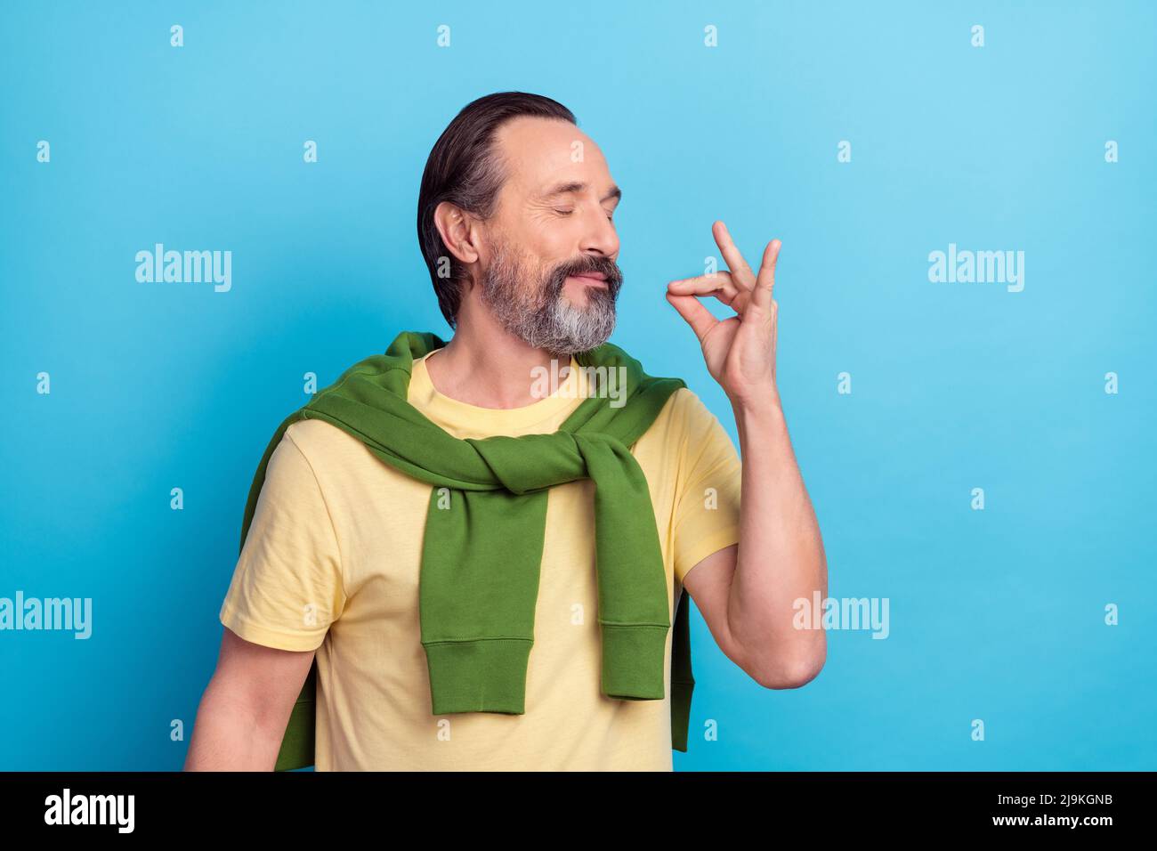 Photo of satisfied glad man closed eyes arm fingers demonstrate gourmet ...