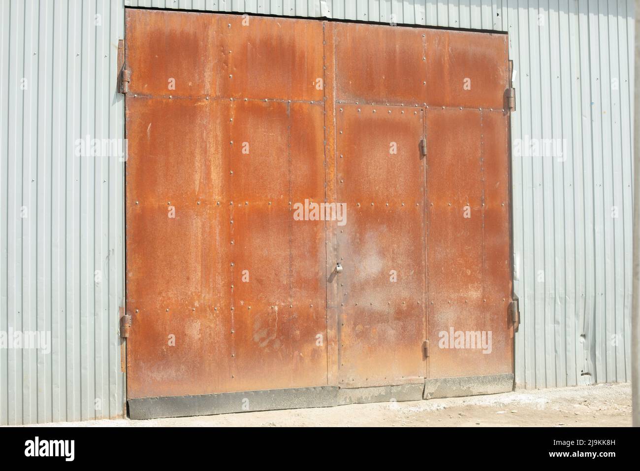 Rusty gates. Entrance to workshop. Industry in detail. Rusty metal ...