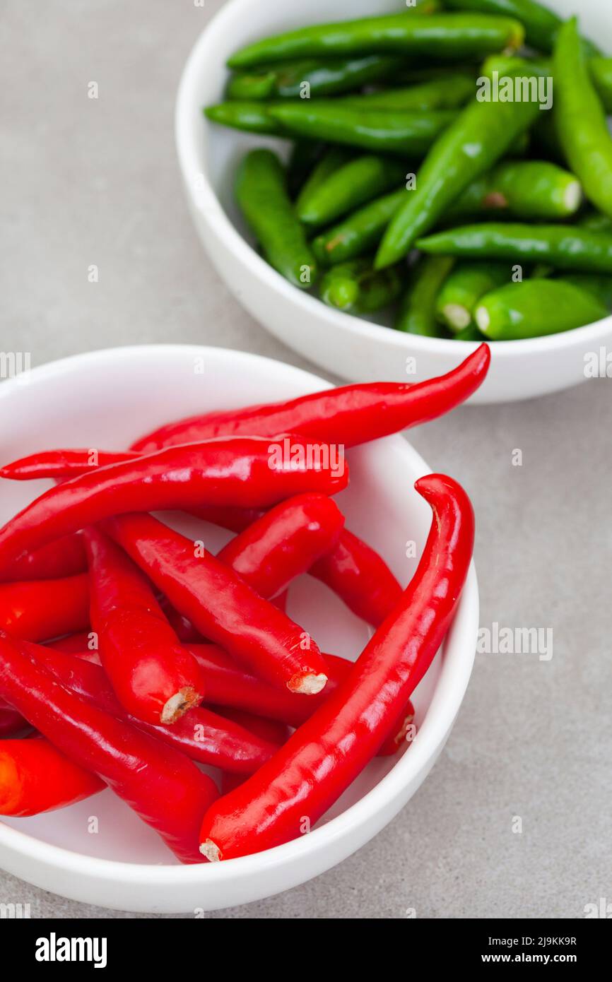 bright small red and green chilies on light grey with copy space Stock ...