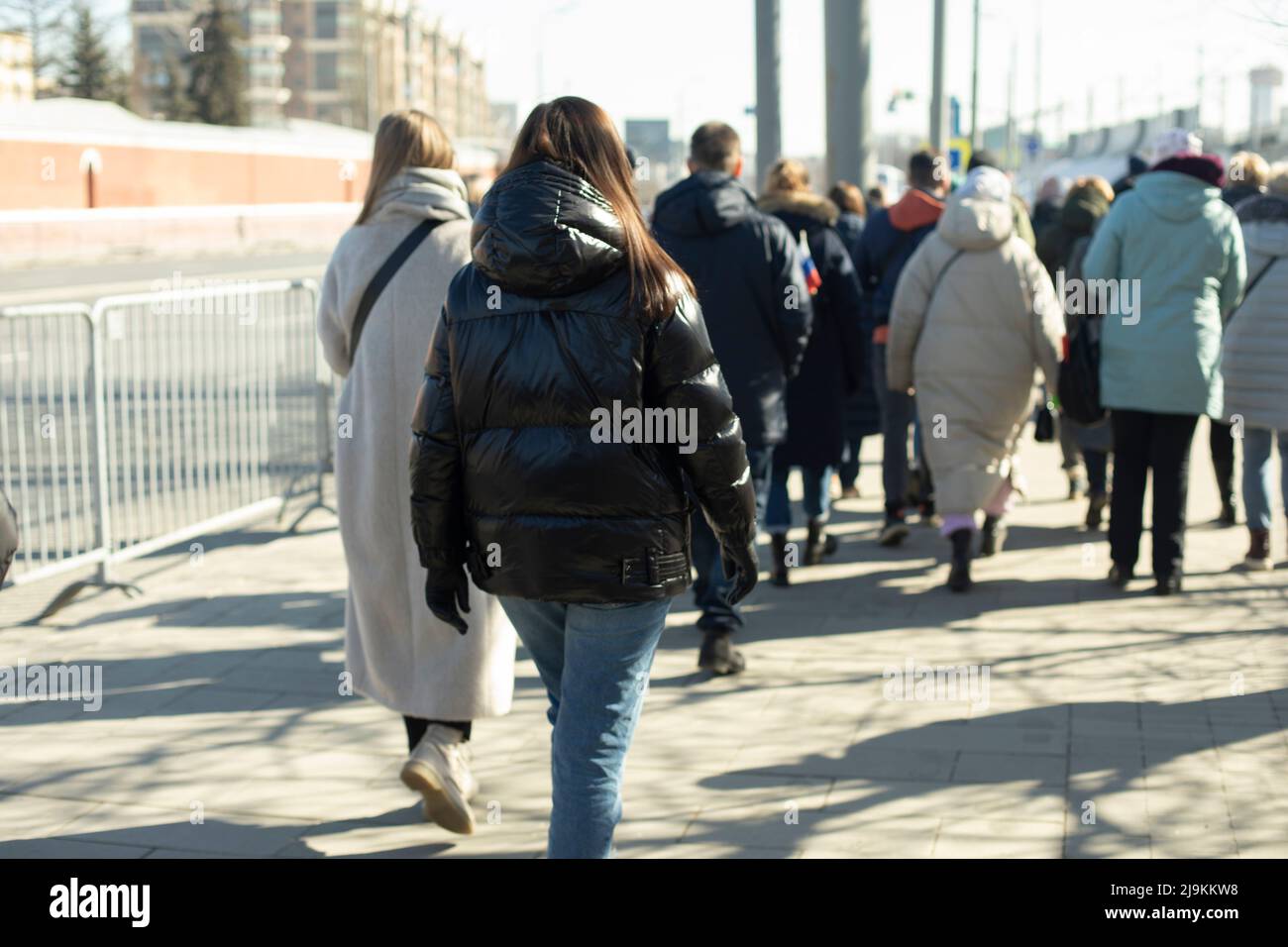 People walk around city in spring. Citizens on street. Lot of people ...
