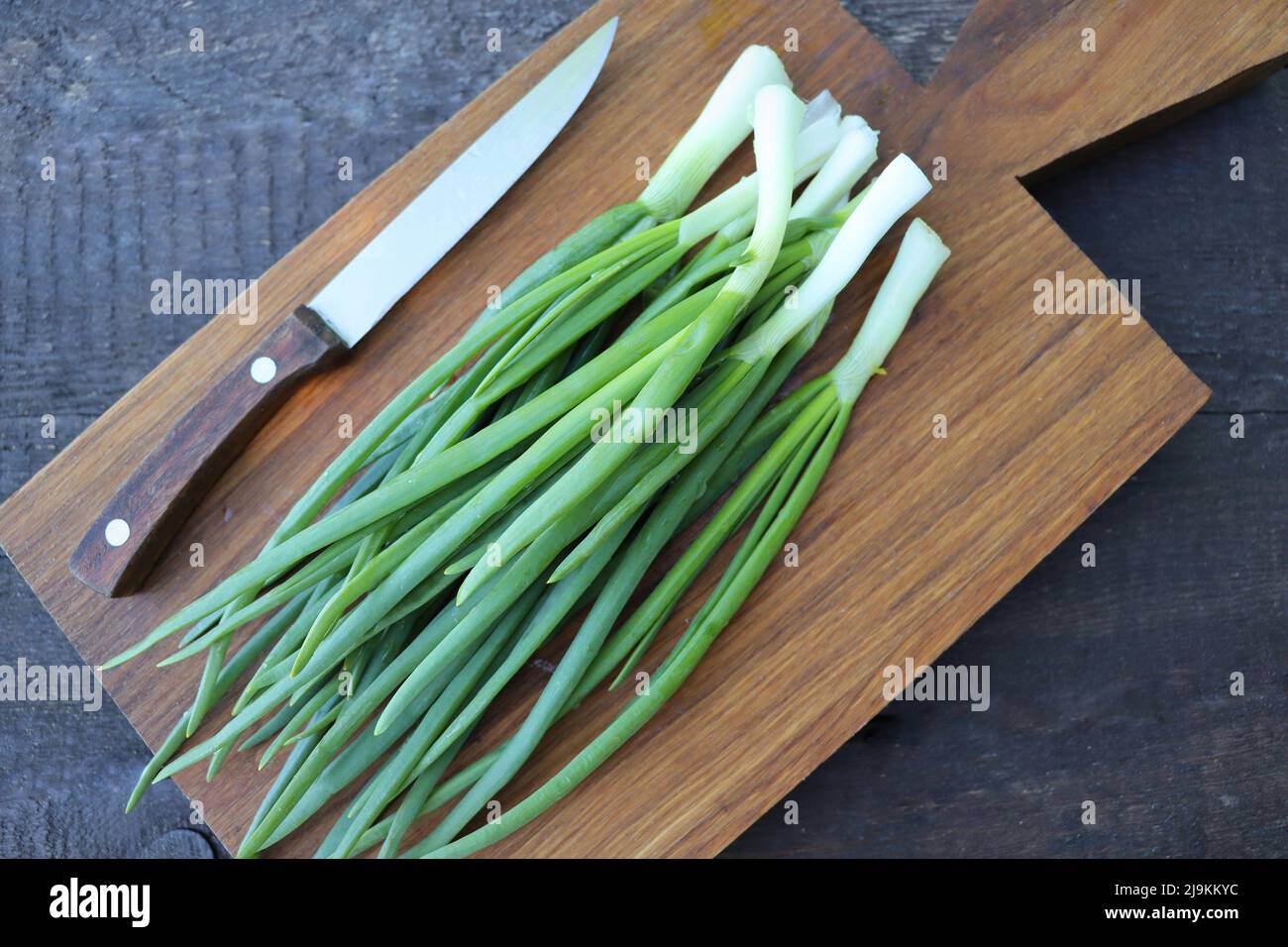 Cutting green onions on black hi-res stock photography and images - Alamy
