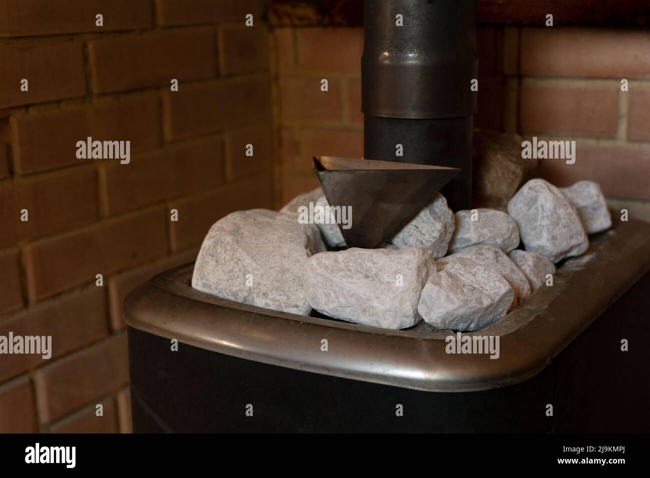Hot stones in furnace for produce steam and heat in steam room. Close ...