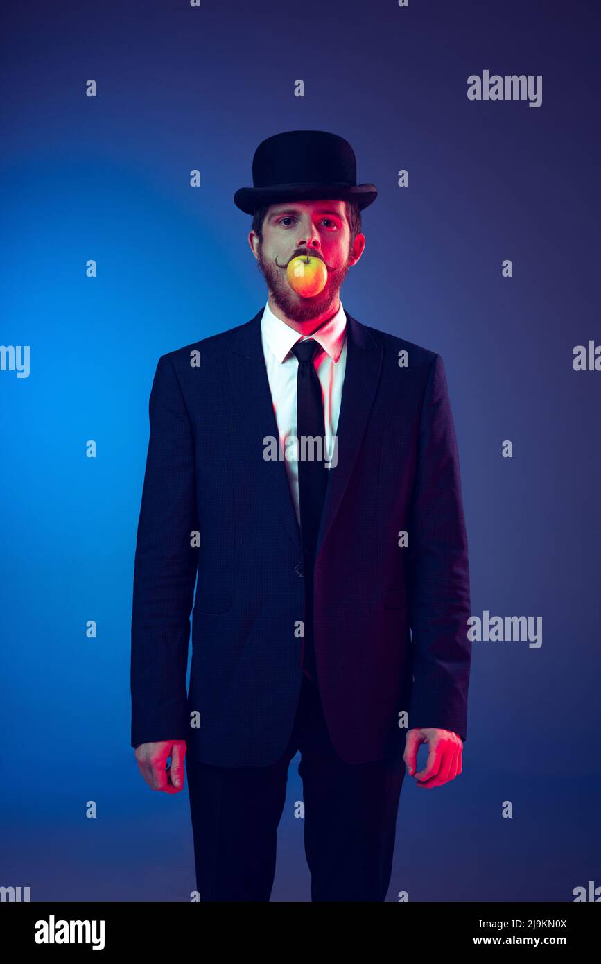 Creative portrait of young stylish man in business suit and bowler hat ...