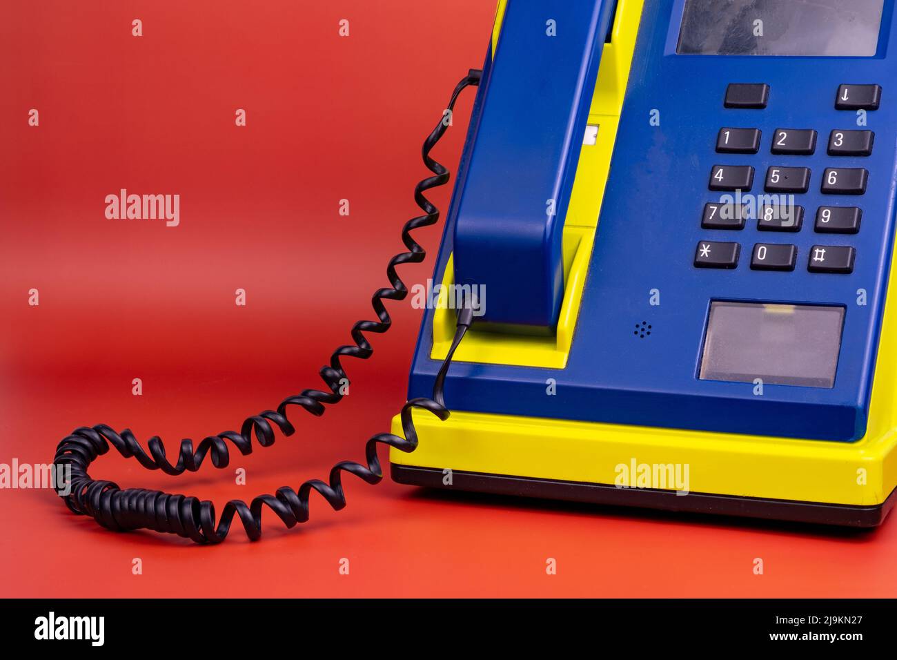 Old telephone booth with an orange background Stock Photo - Alamy